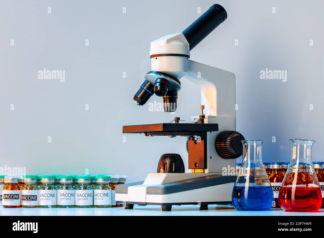 Medical vial with medication near microscope photo Stock Photo - Alamy