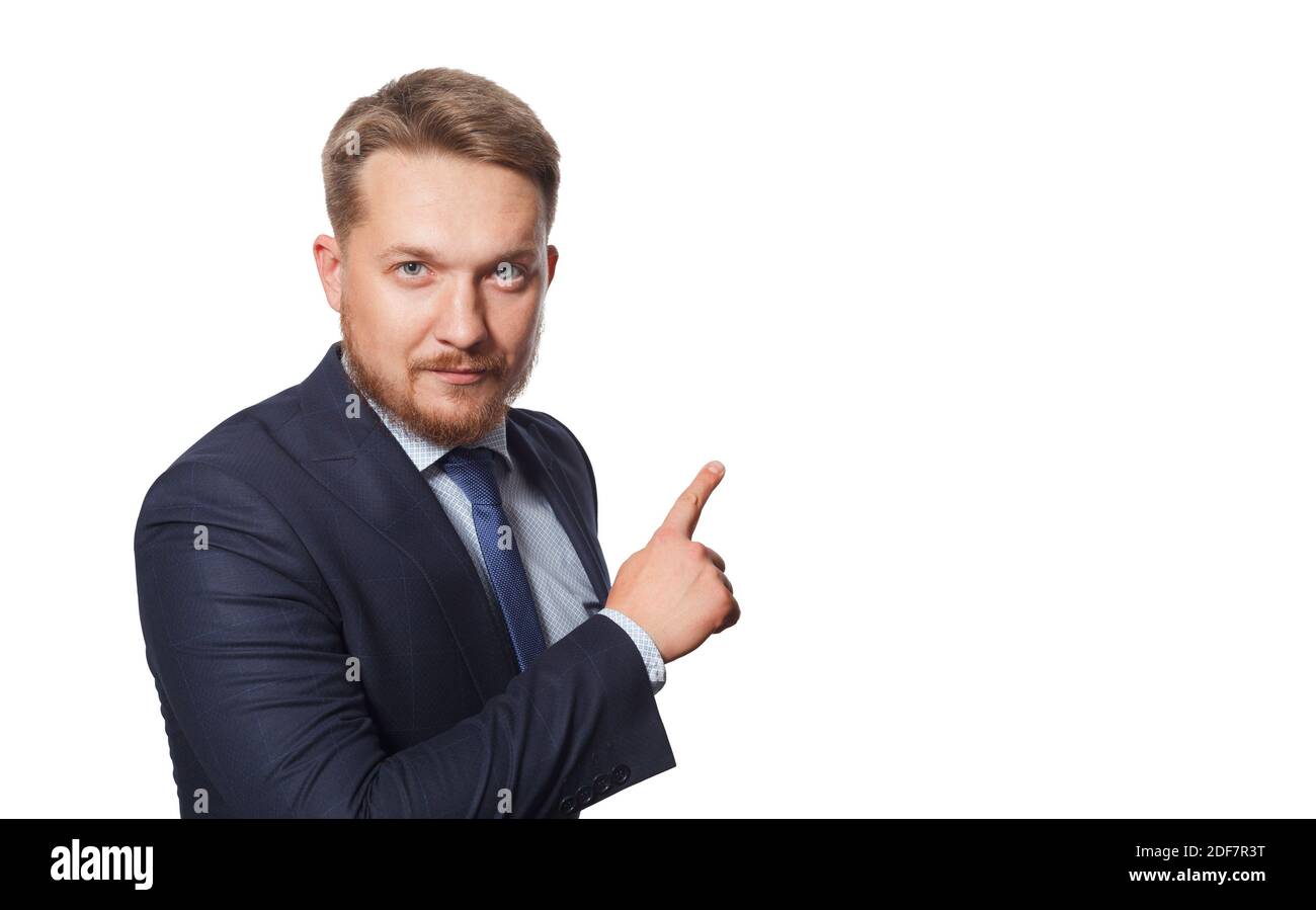 Serious man pointing away while standing against white background Stock ...