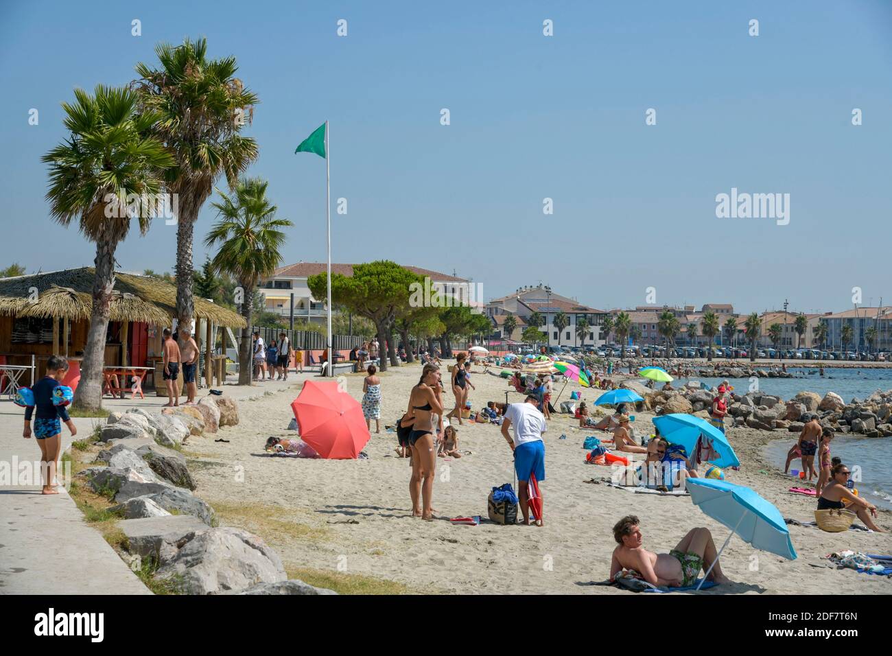 France, Herault, Thau lagoon, Meze, vacationerson a beach lined with ...