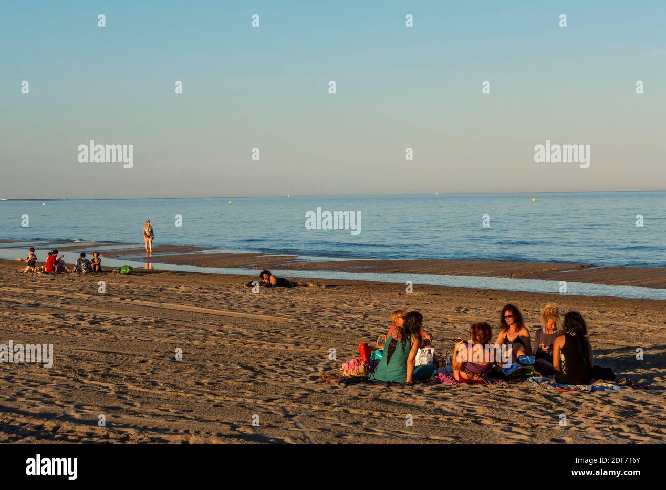France, Herault, Sete, Beach of 3 Digues, group of friends on a beach ...