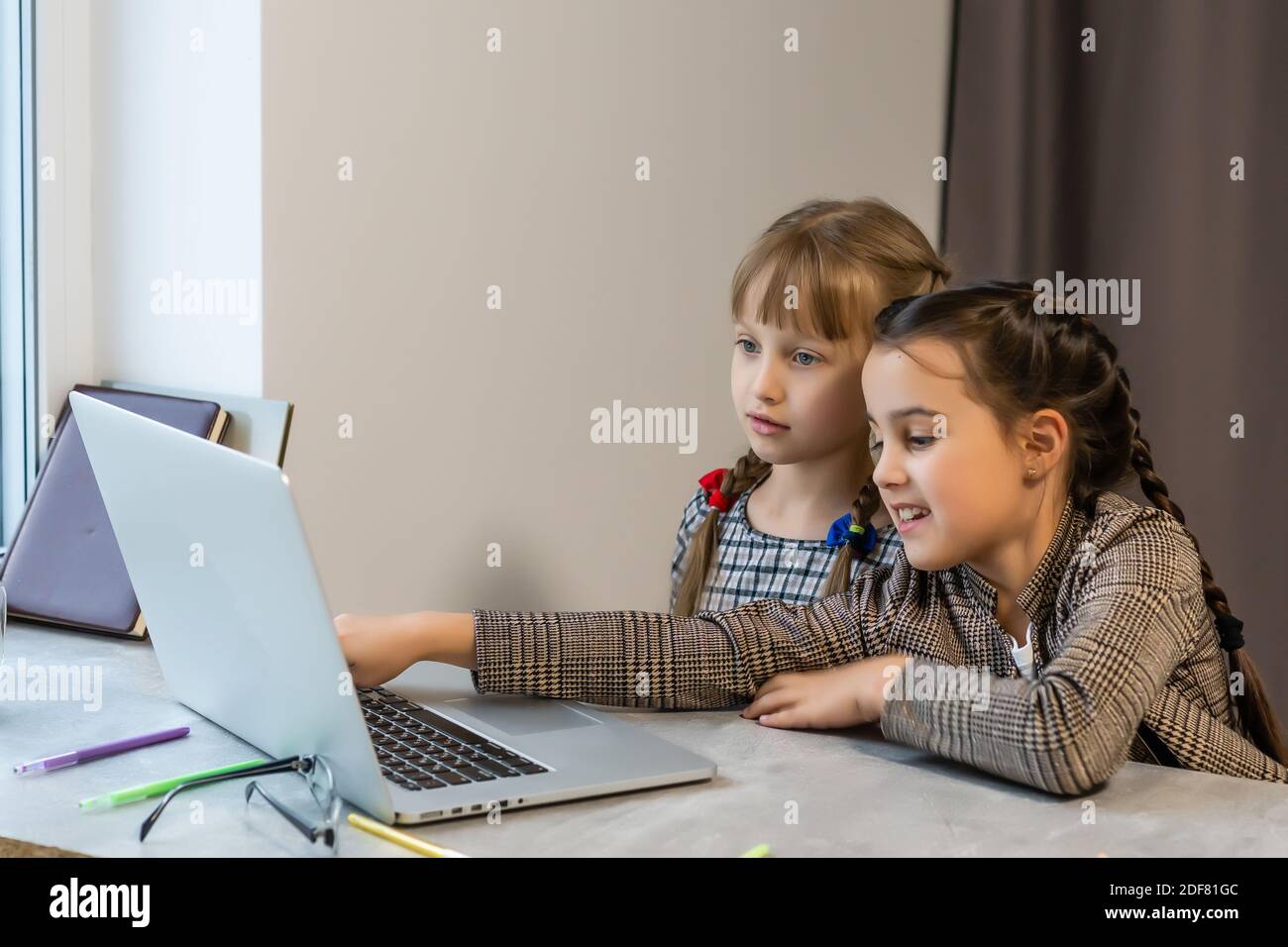 Two little girls doing their school homework Stock Photo - Alamy