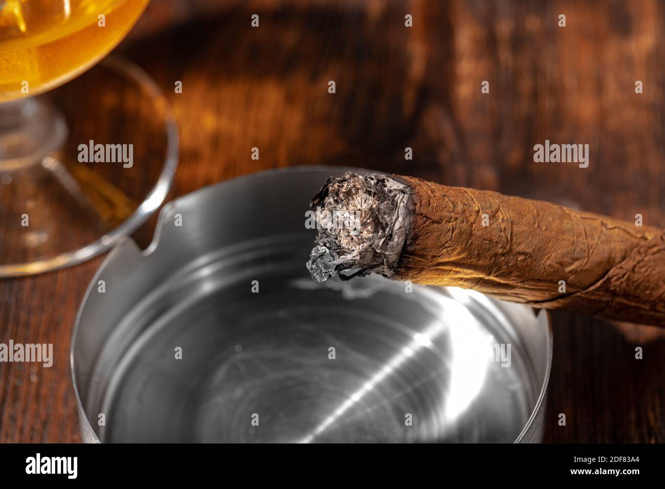 Glass of whisky and lighted cigar in an ash tray Stock Photo - Alamy