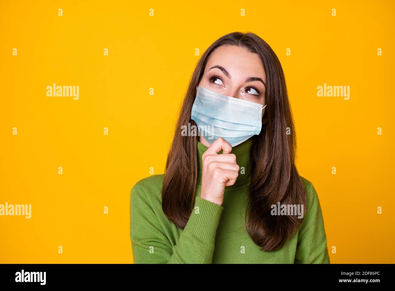 Close-up portrait of smart girl creating new solution wearing blue face ...