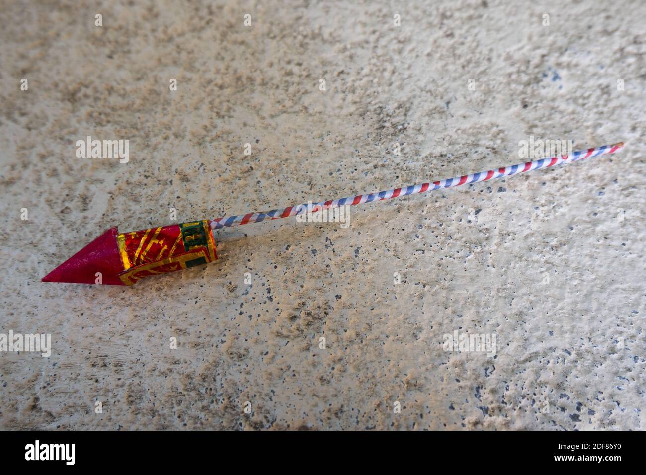 A high angle shot of a firework rocket on a concrete surface Stock ...