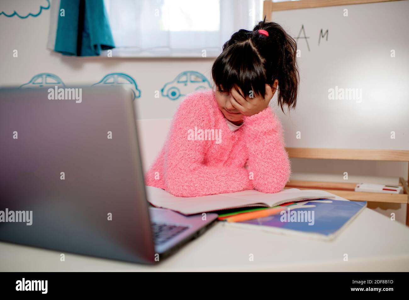 Tired school girl studying at home Stock Photo - Alamy