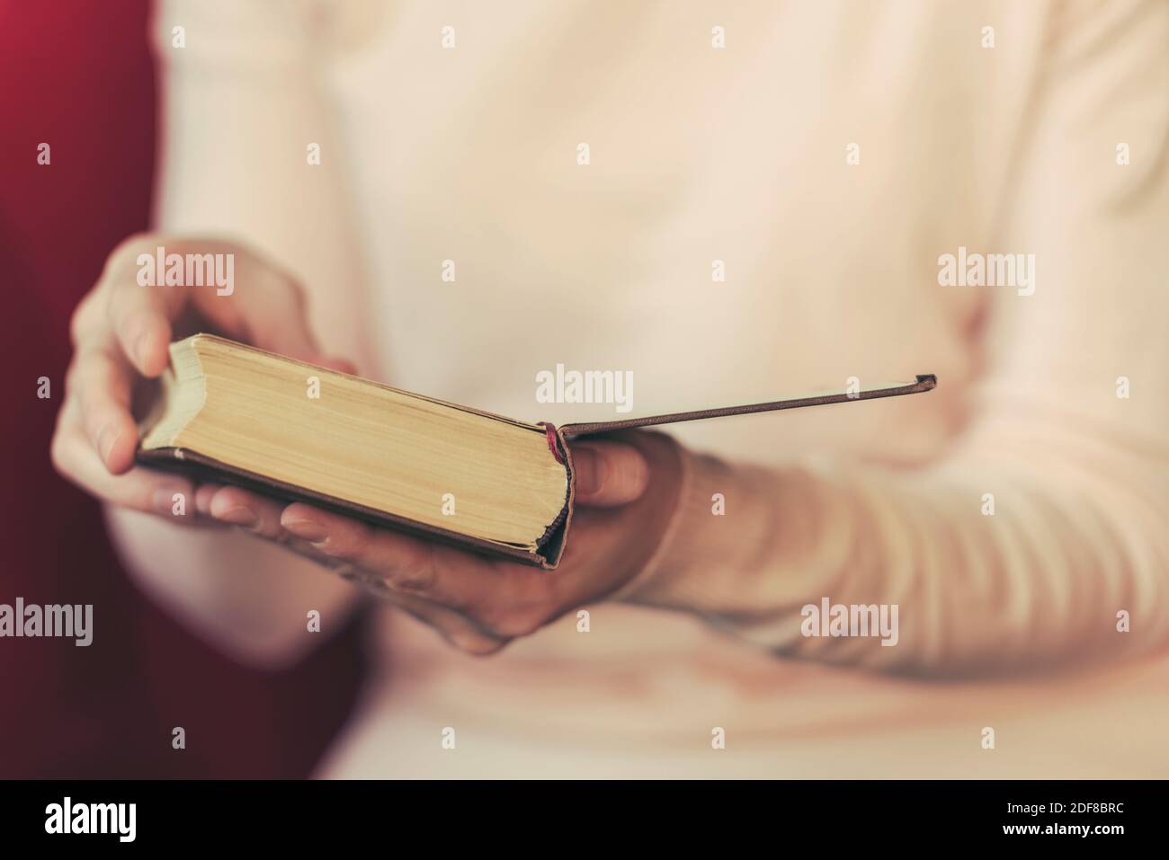 Girl reading book, woman holding open book, toned picture Stock Photo ...