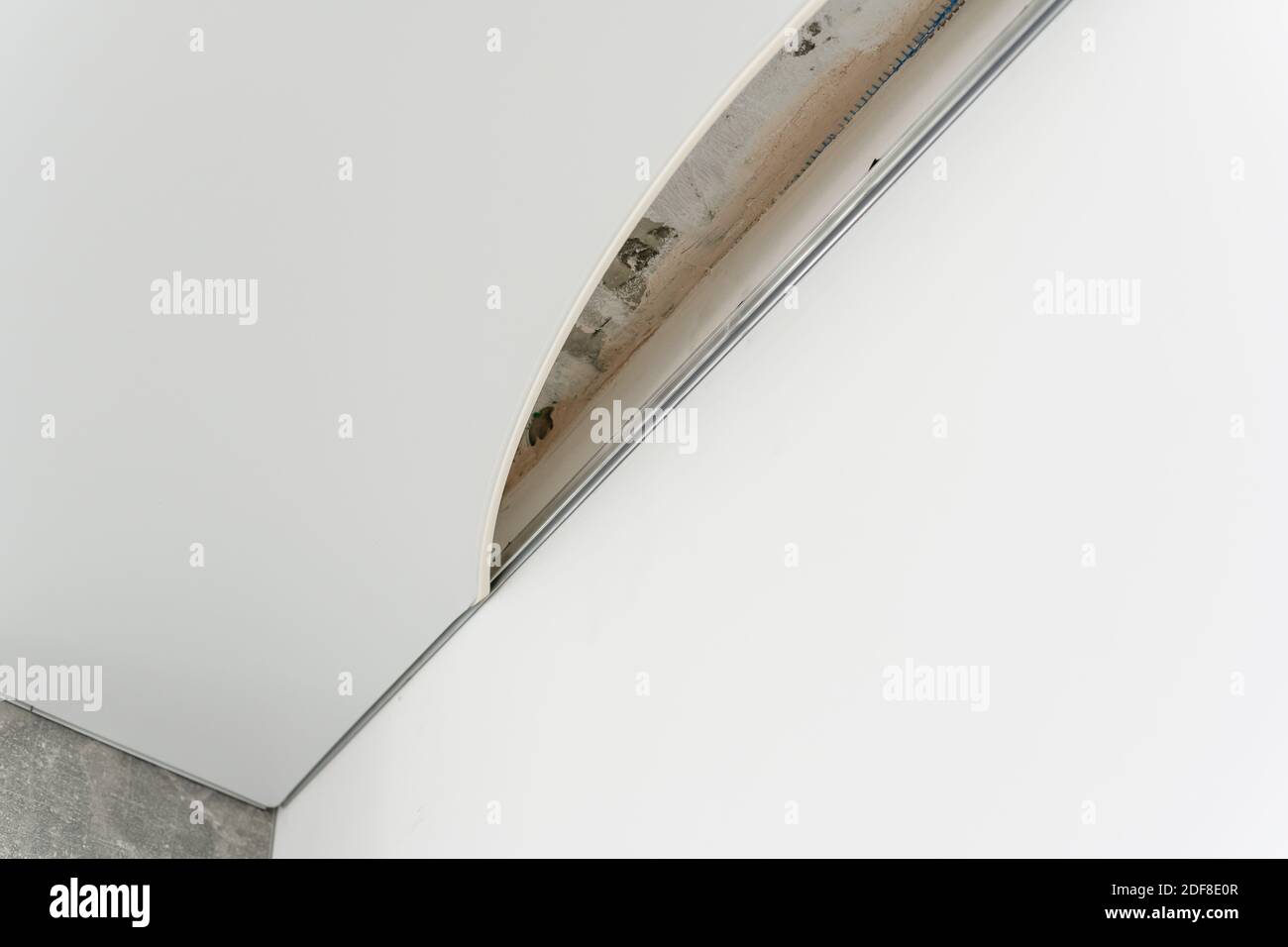 repairmen install stretch ceiling made of pvc vinyl film using a gas ...