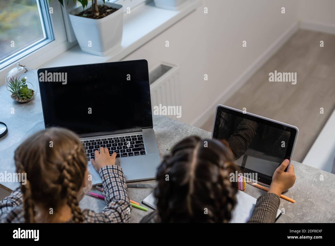 Two little girls doing their school homework Stock Photo - Alamy