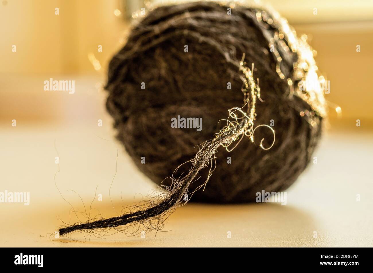 Thick thread in a ball of brown wool Stock Photo - Alamy