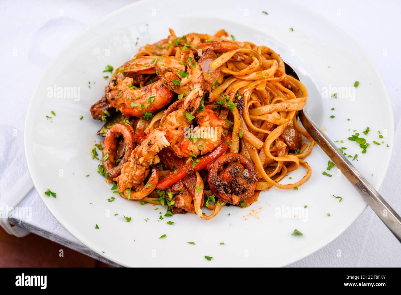 Pasta with grilled seafood. Traditional Greek dish Stock Photo - Alamy