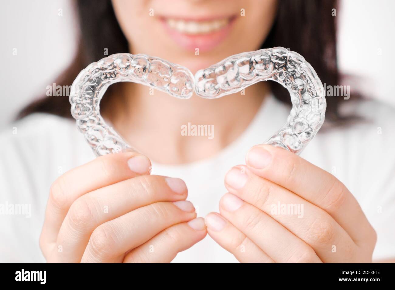 Making heart from aligners or removable braces Stock Photo - Alamy