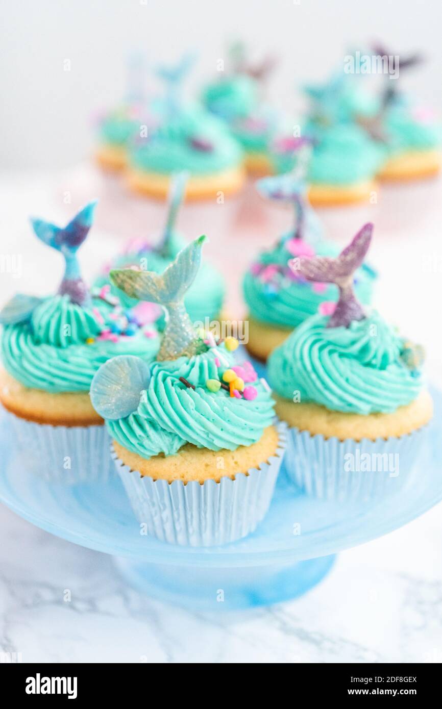 Gourmet mermaid cupcakes topped with blue buttercream frosting and ...