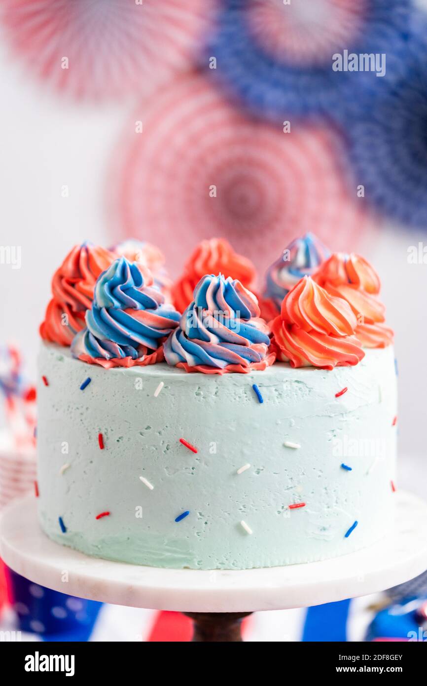 Red, white, and blue round vanilla cake with buttercream frosting for ...