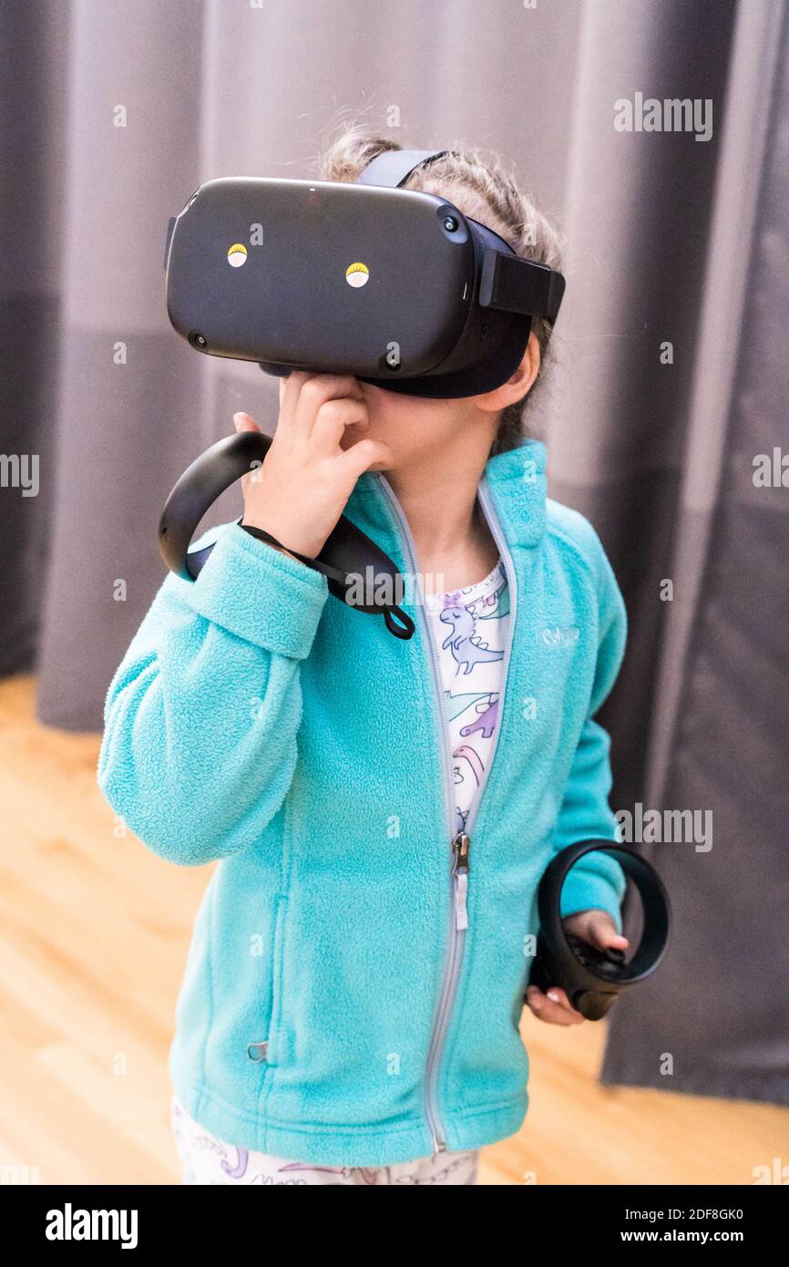 Little girl playing VR kids game in the living room Stock Photo - Alamy