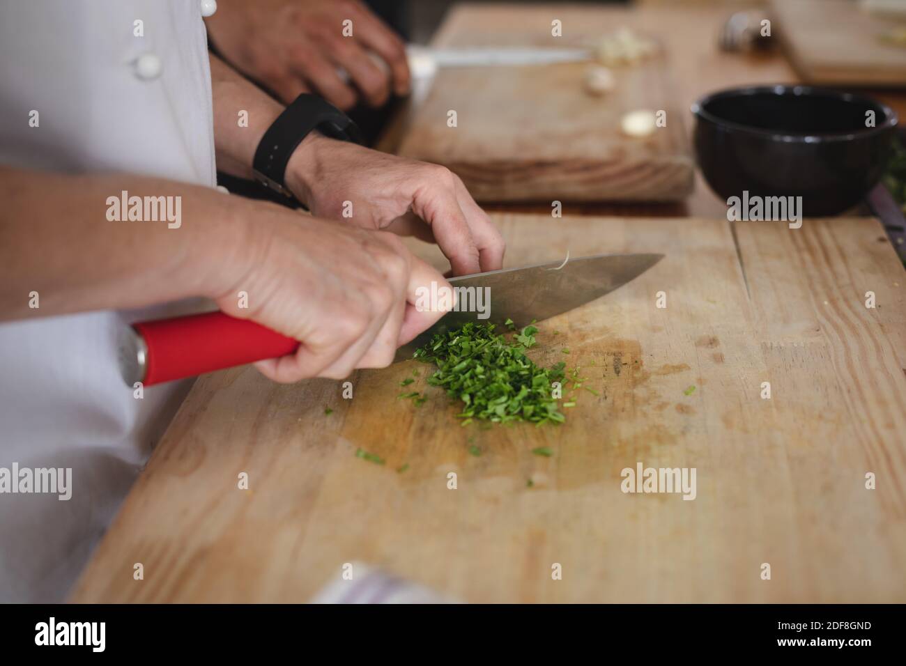 Female chef and mixed race male chef in kitchen Stock Photo - Alamy