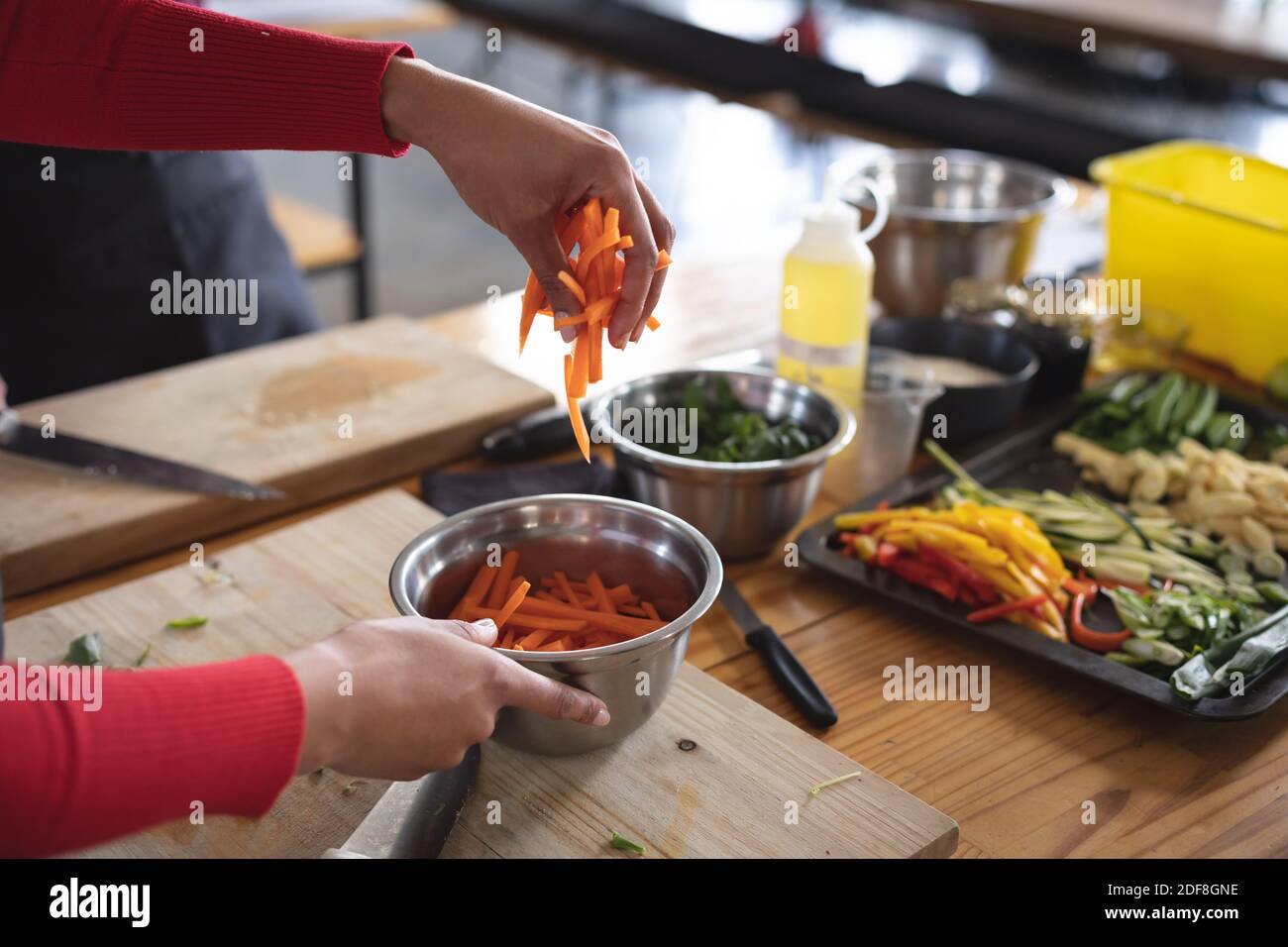 Mixed race female chef cooking in kitchen Stock Photo - Alamy