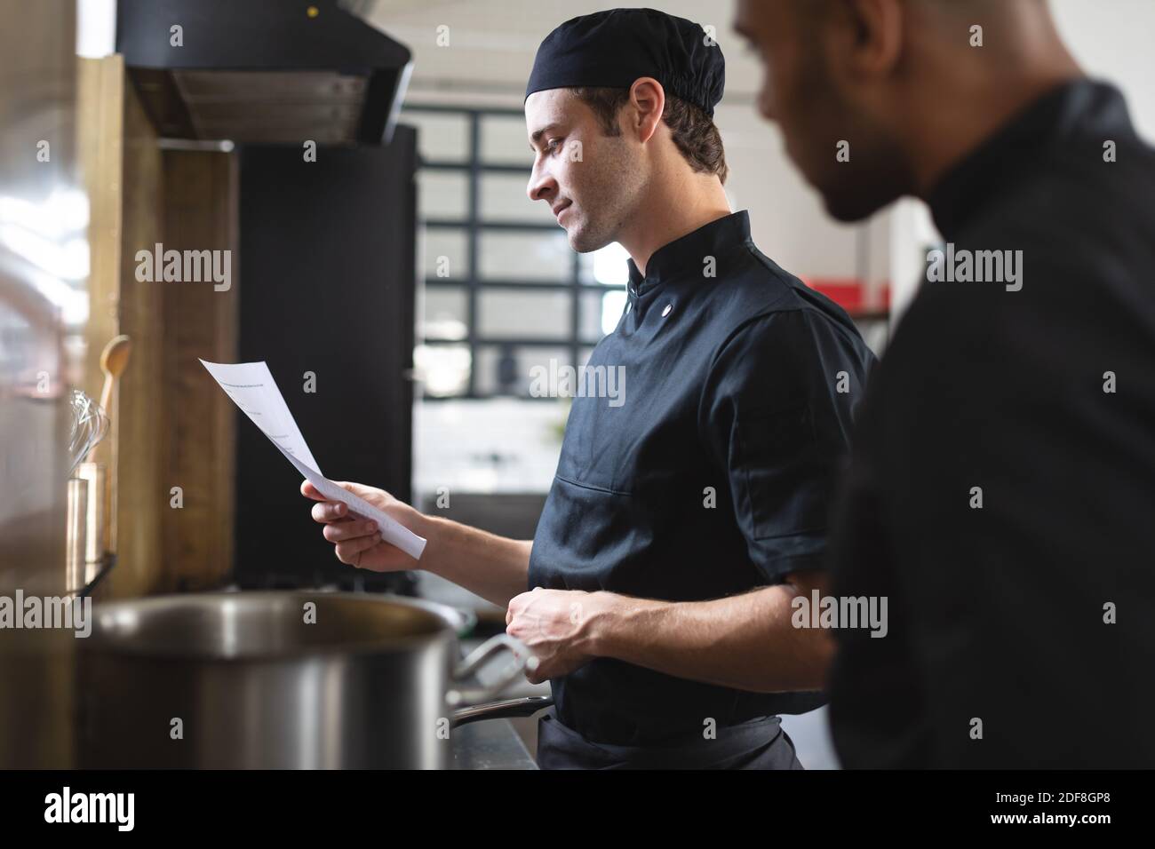 Two diverse male chefs in kitchen Stock Photo - Alamy