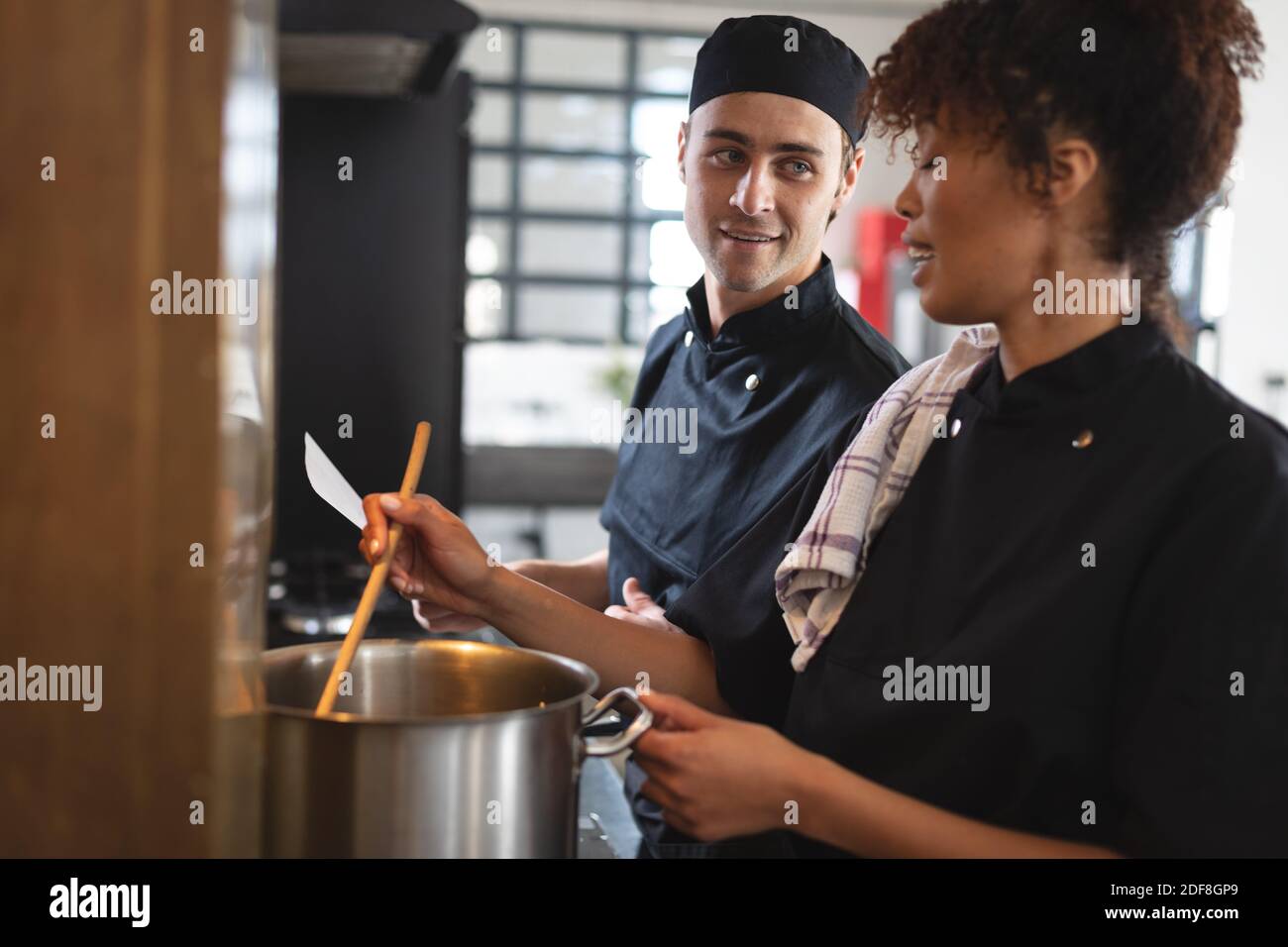 Two diverse male and female chefs in kitchen Stock Photo - Alamy