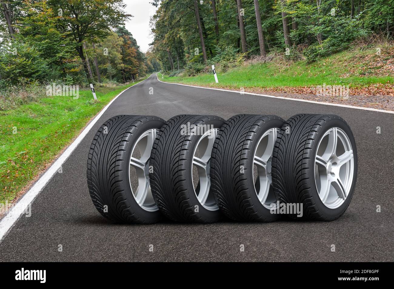 Car wheels set - four car wheels arranged in a row on the asphalt road ...
