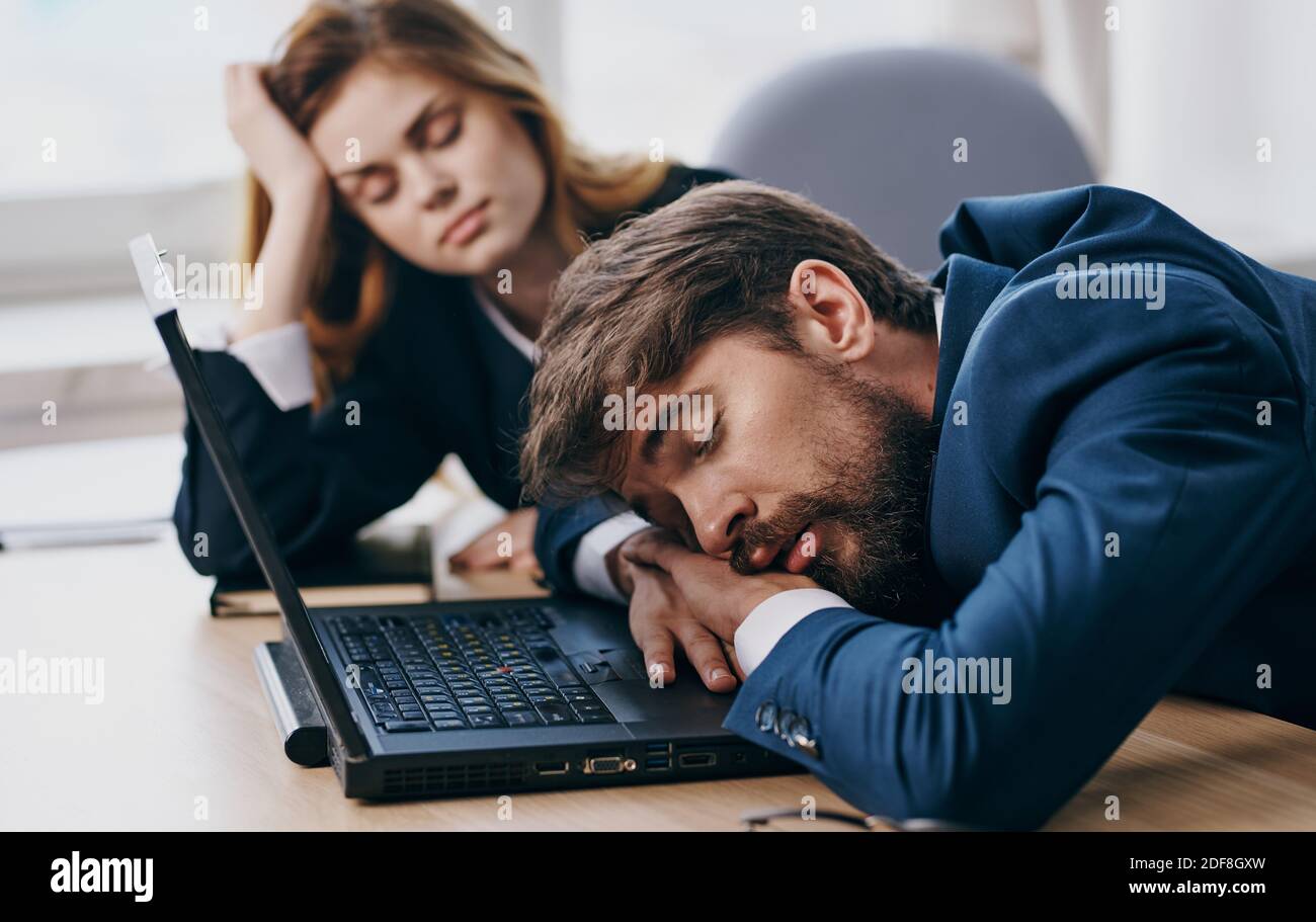 Work colleagues asleep at the desk in front of the laptop fatigue rest ...