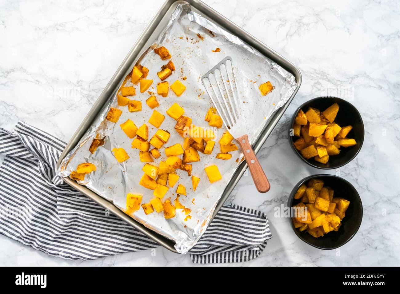 Flat lay. Roasting butternut squash with salt and pepper in olive oil ...