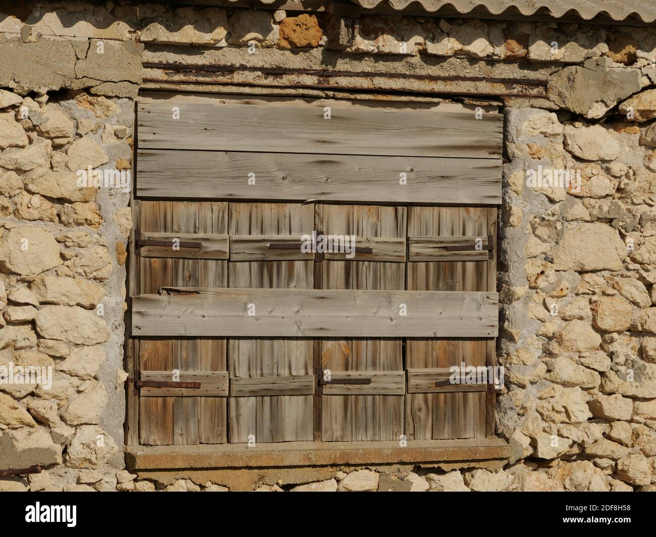 An old wooden gate of an old stone house Stock Photo - Alamy
