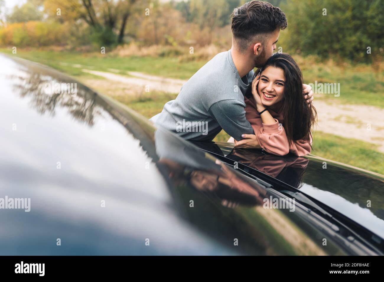 Romantic couple having fun fooling around near the car in nature Stock ...