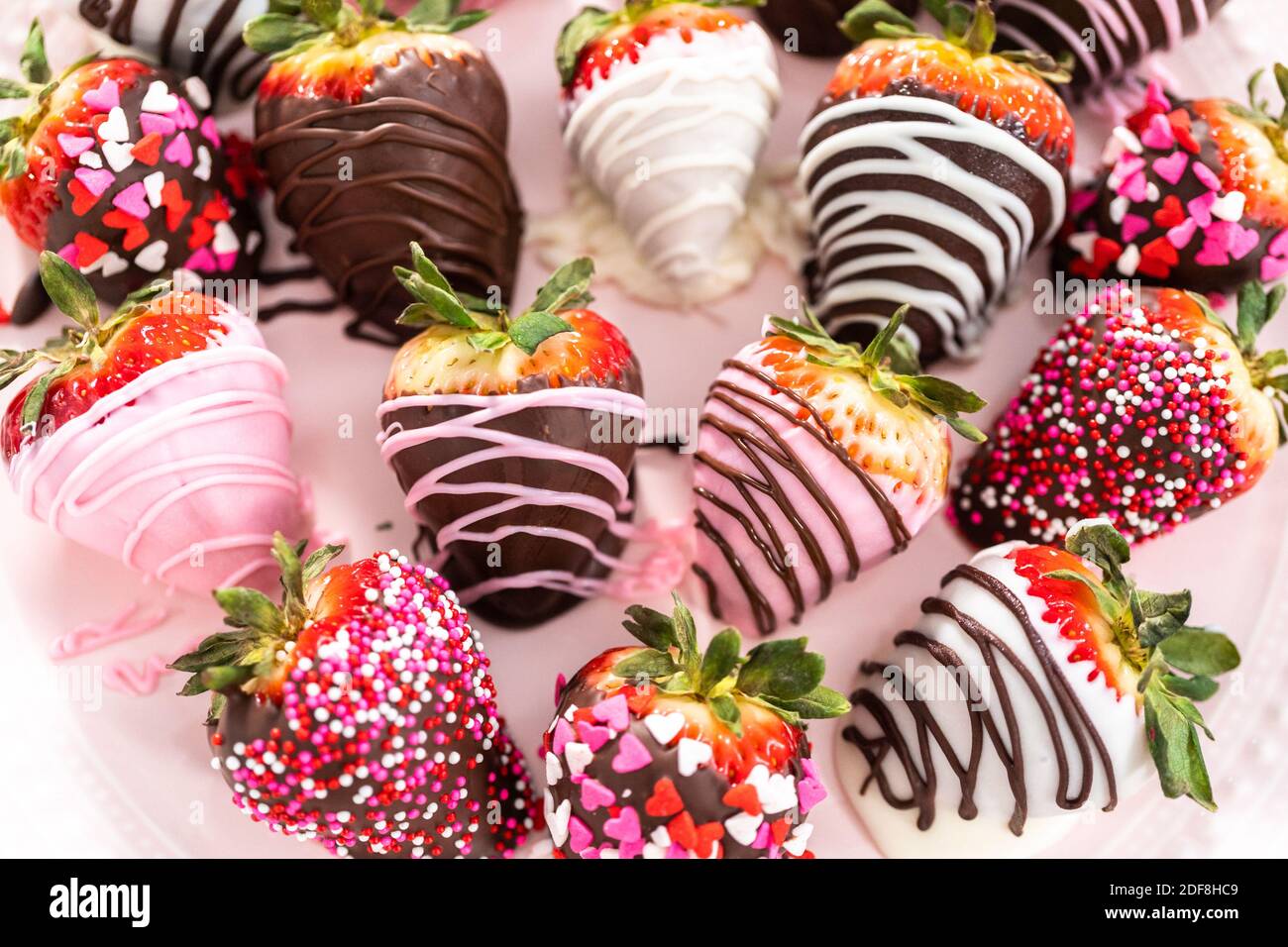 Variety of chocolate dipped strawberries on a pink cake stand Stock ...