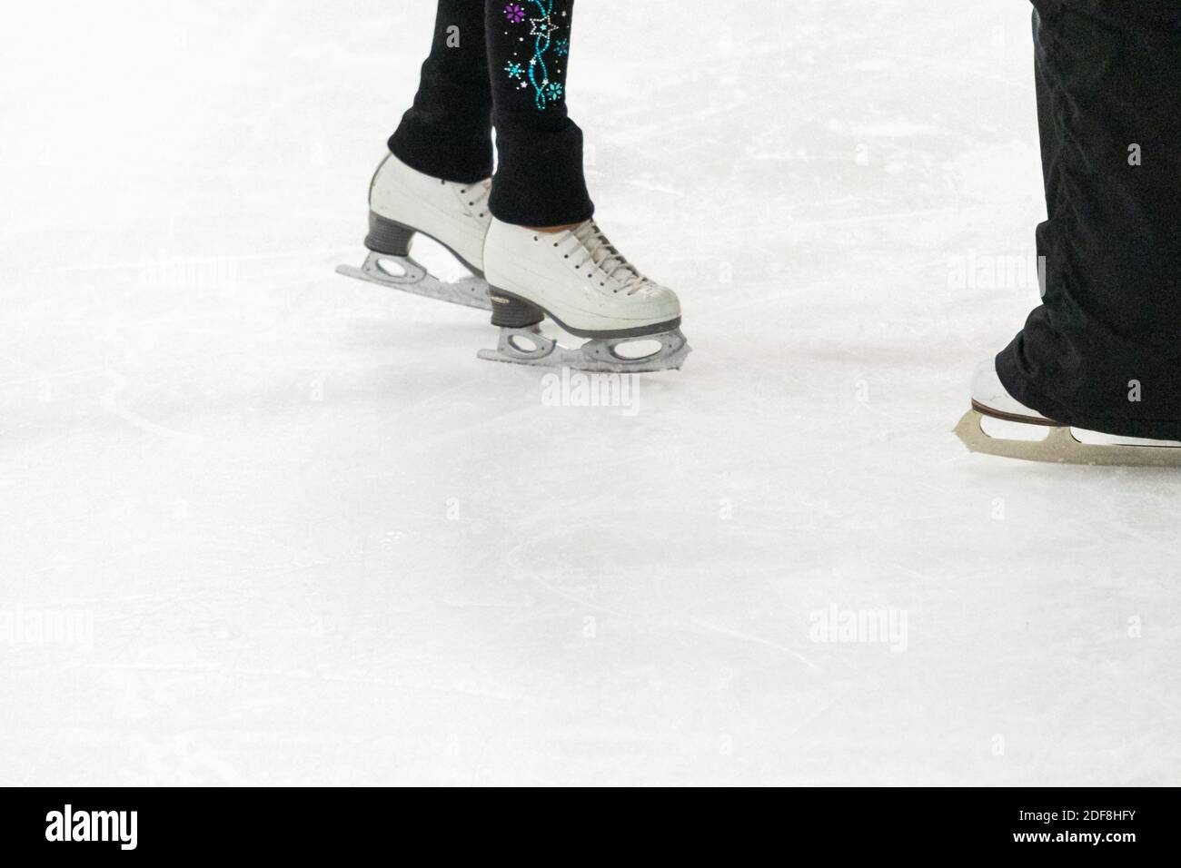 View of a figure skater and her coach feet at the figure skating ...