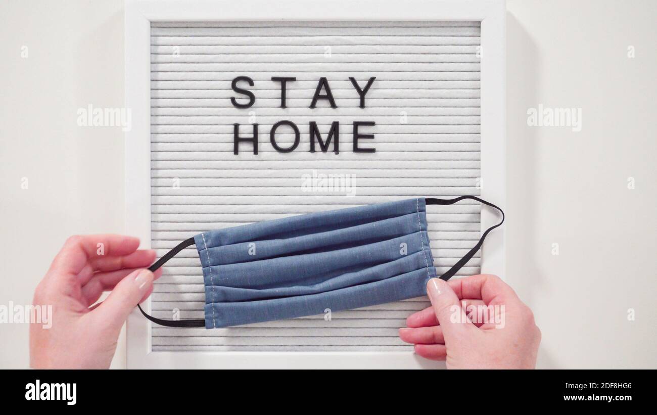 Flat lay. STAY HOME and STAY SAFE sign on message board with a homemade ...