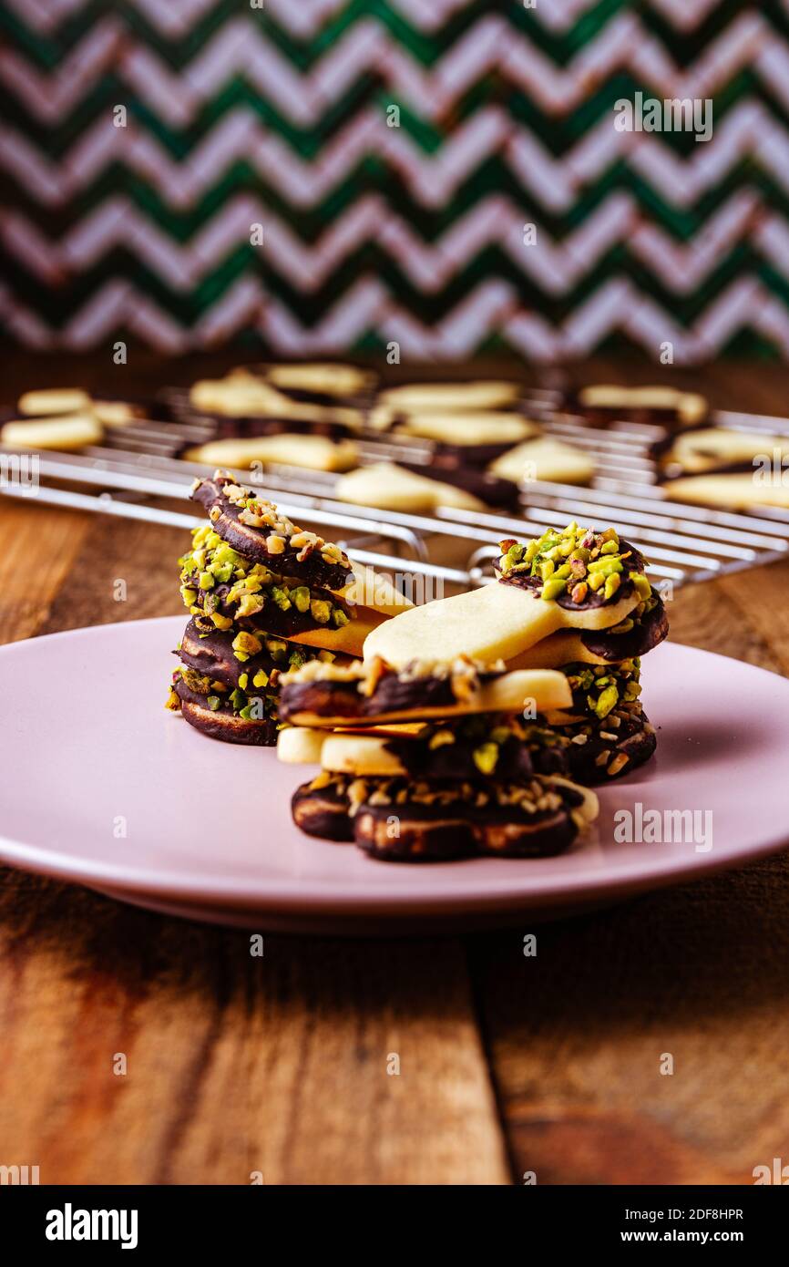 A vertical closeup of cookies on a plate and on iron bars Stock Photo ...
