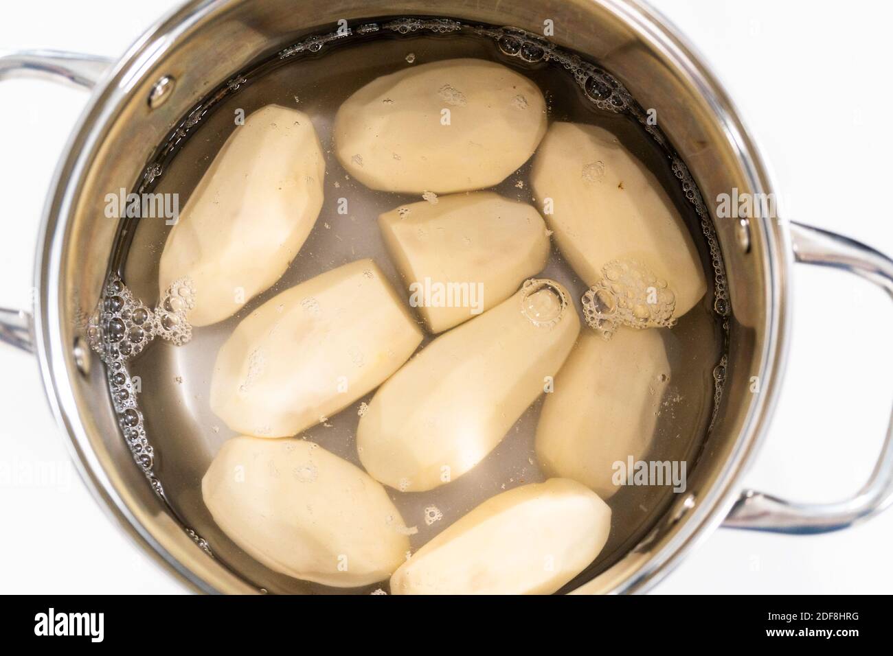 Boiling peeled large potatoes in a cooking pot Stock Photo - Alamy