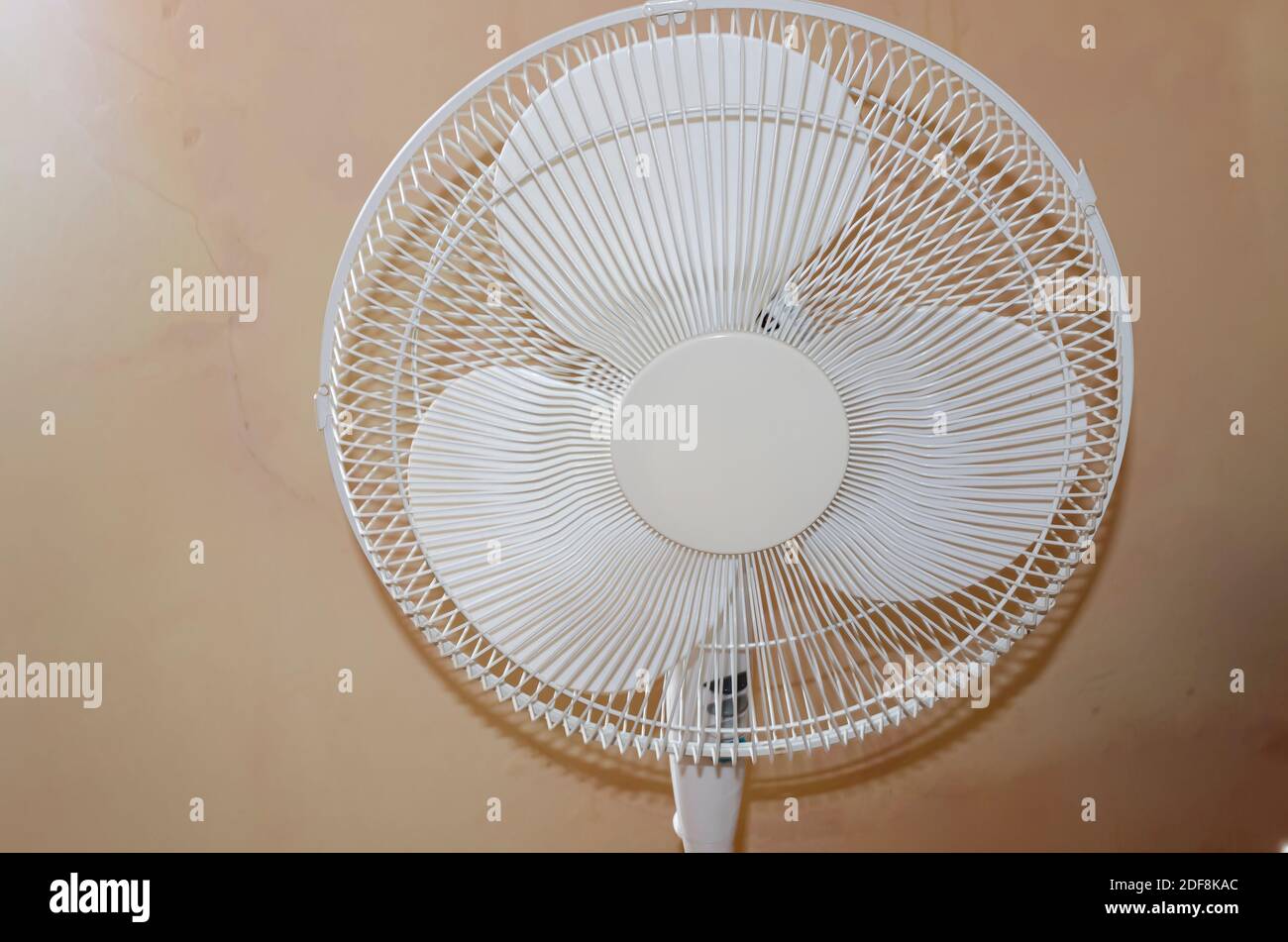 White Fan Against Concrete Wall Background Stock Photo - Alamy