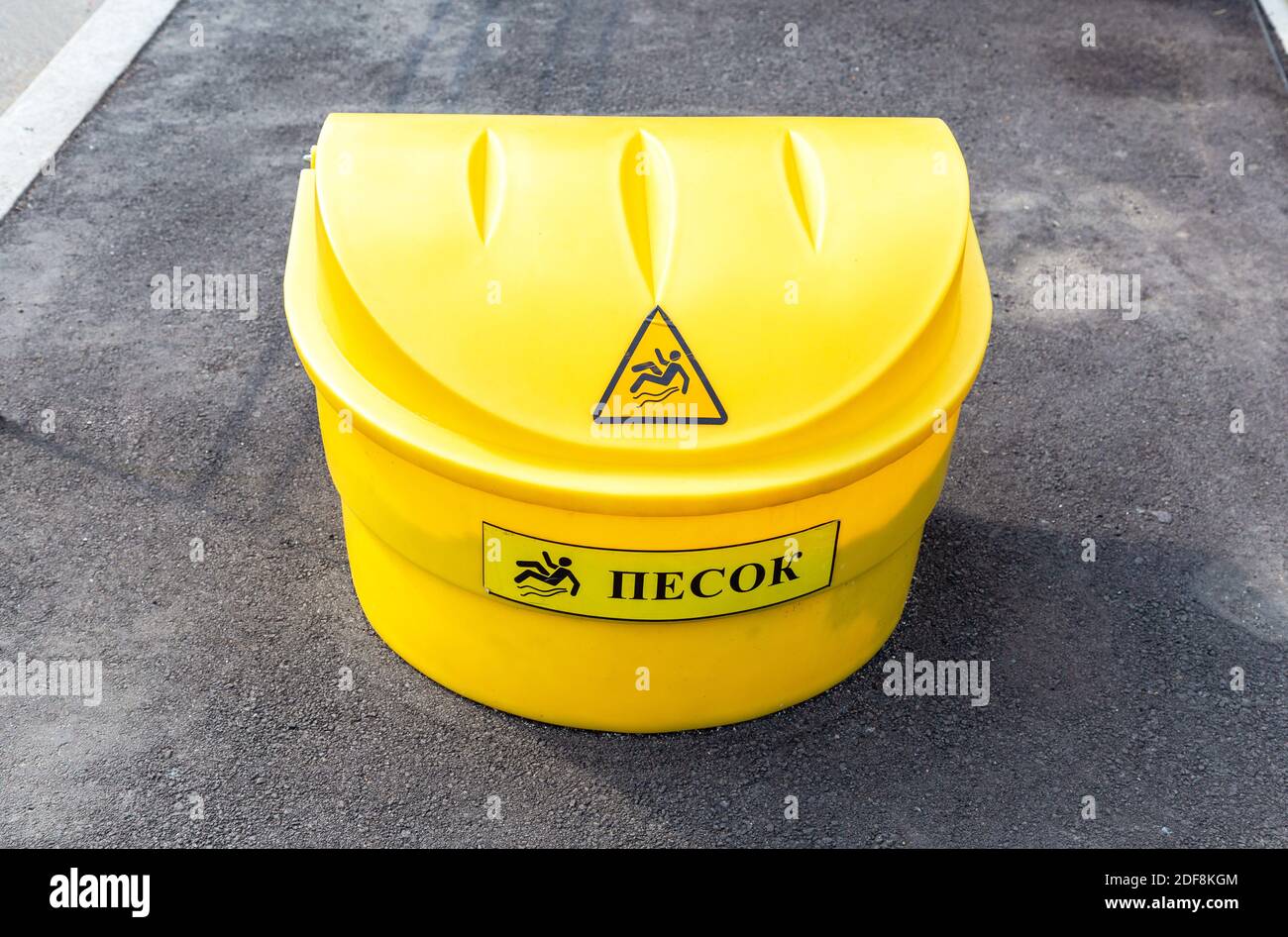 Yellow plastic sand container close up. Text in russian: Sand Stock ...