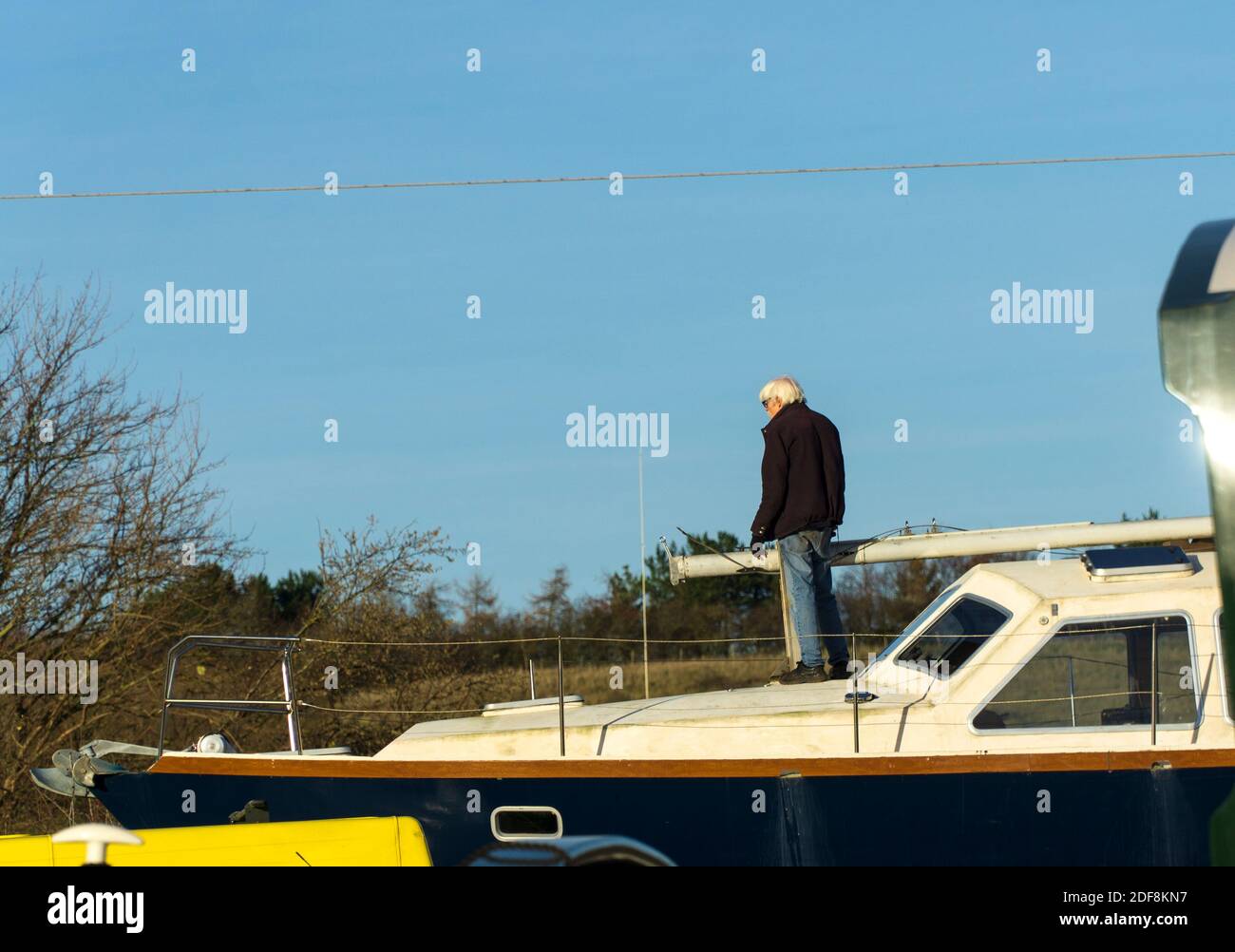 Man standing on a boat deck Stock Photo - Alamy