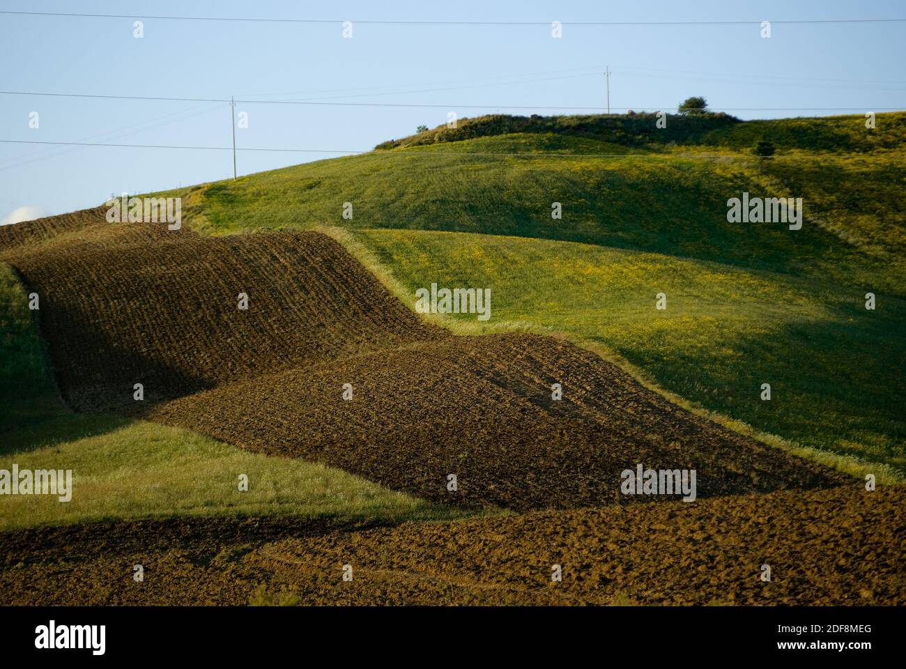 rolling landscape for red plowed land and green field Stock Photo - Alamy