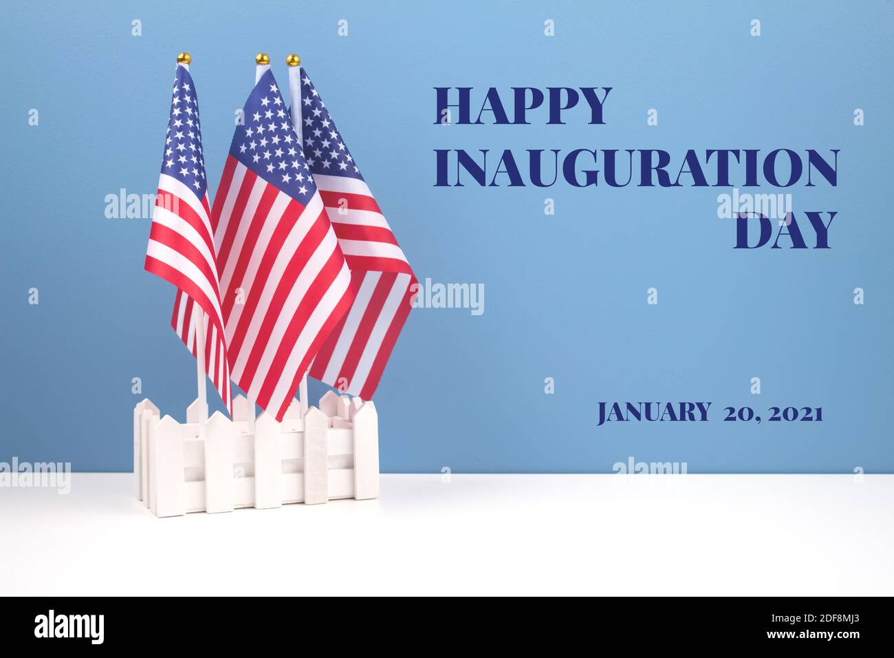 Creative composition with USA flags on white table with blue wall ...