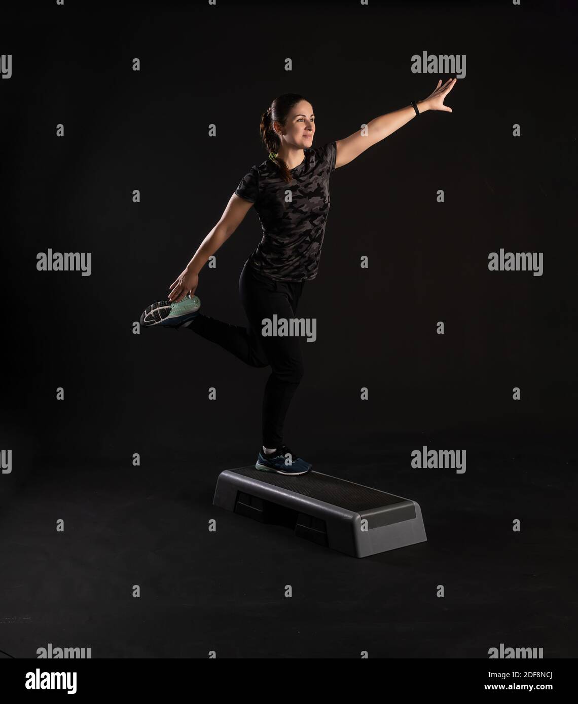 Fitness on the step platform, moving. Go in for sports on a black ...