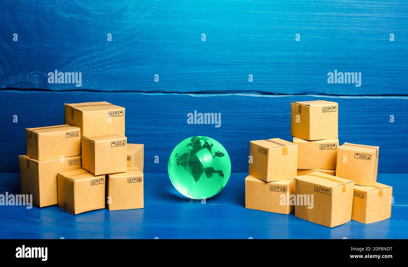 Planet Earth globe and cardboard boxes. Delivering goods and products ...
