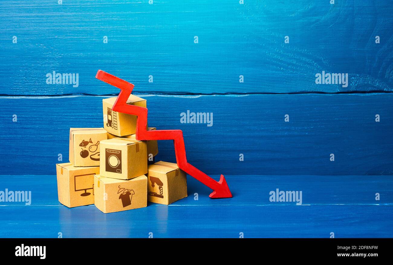Cardboard boxes and red down arrow. Decline in sales and production ...