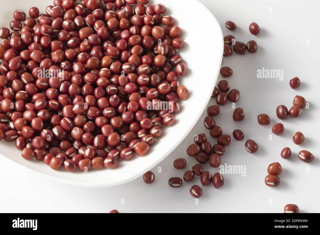 A white bowl of small red beans on white background Stock Photo - Alamy