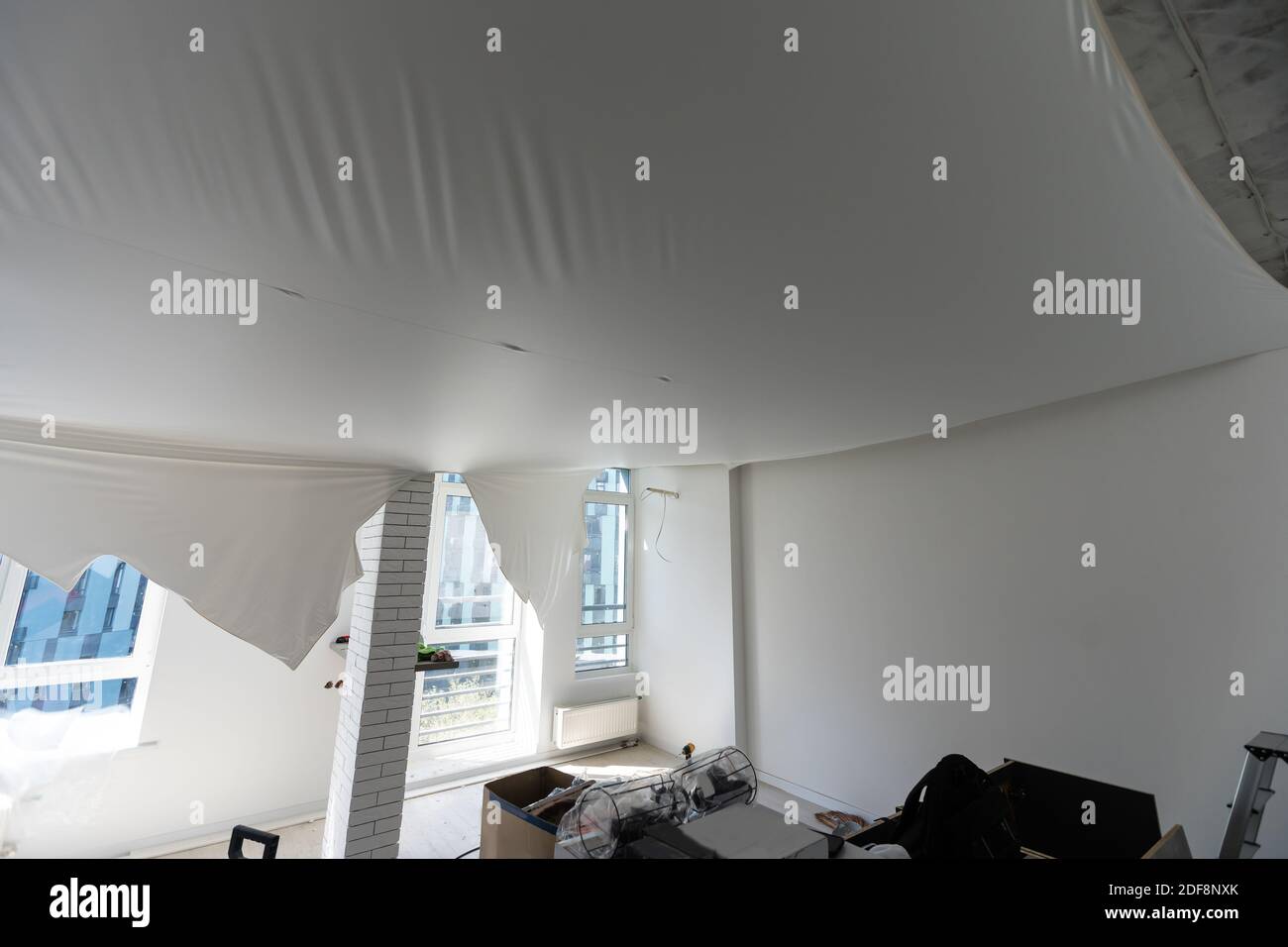 Process of installing stretch ceiling in the hall Stock Photo - Alamy