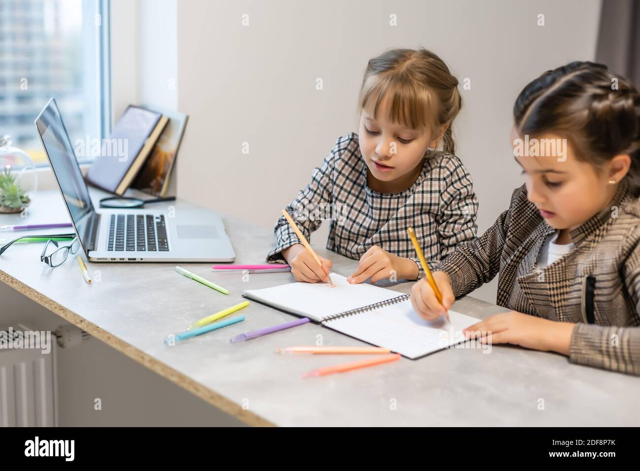 Two little girls doing their school homework Stock Photo - Alamy