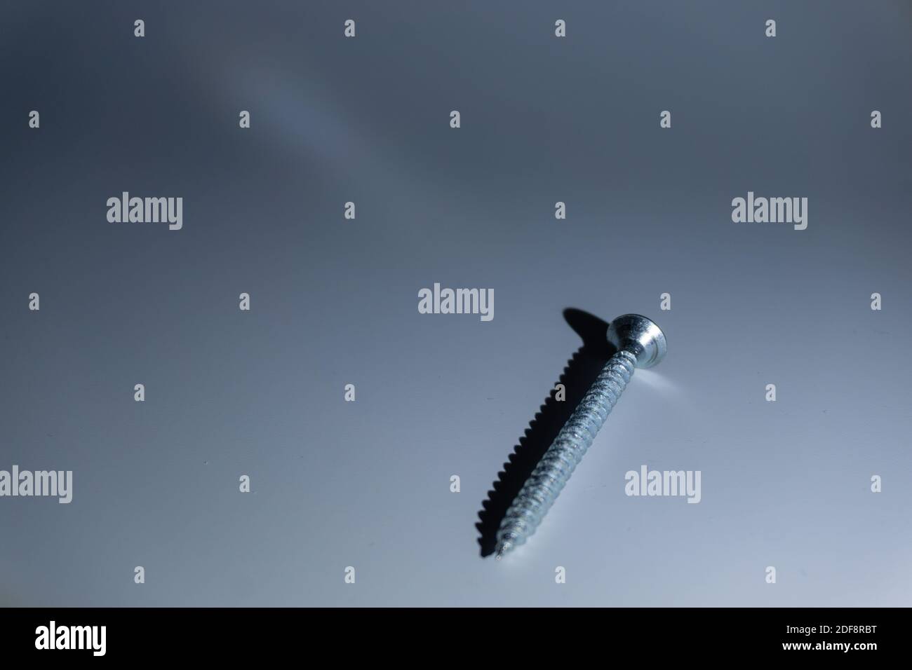 a screw and its shadow on a white background Stock Photo - Alamy