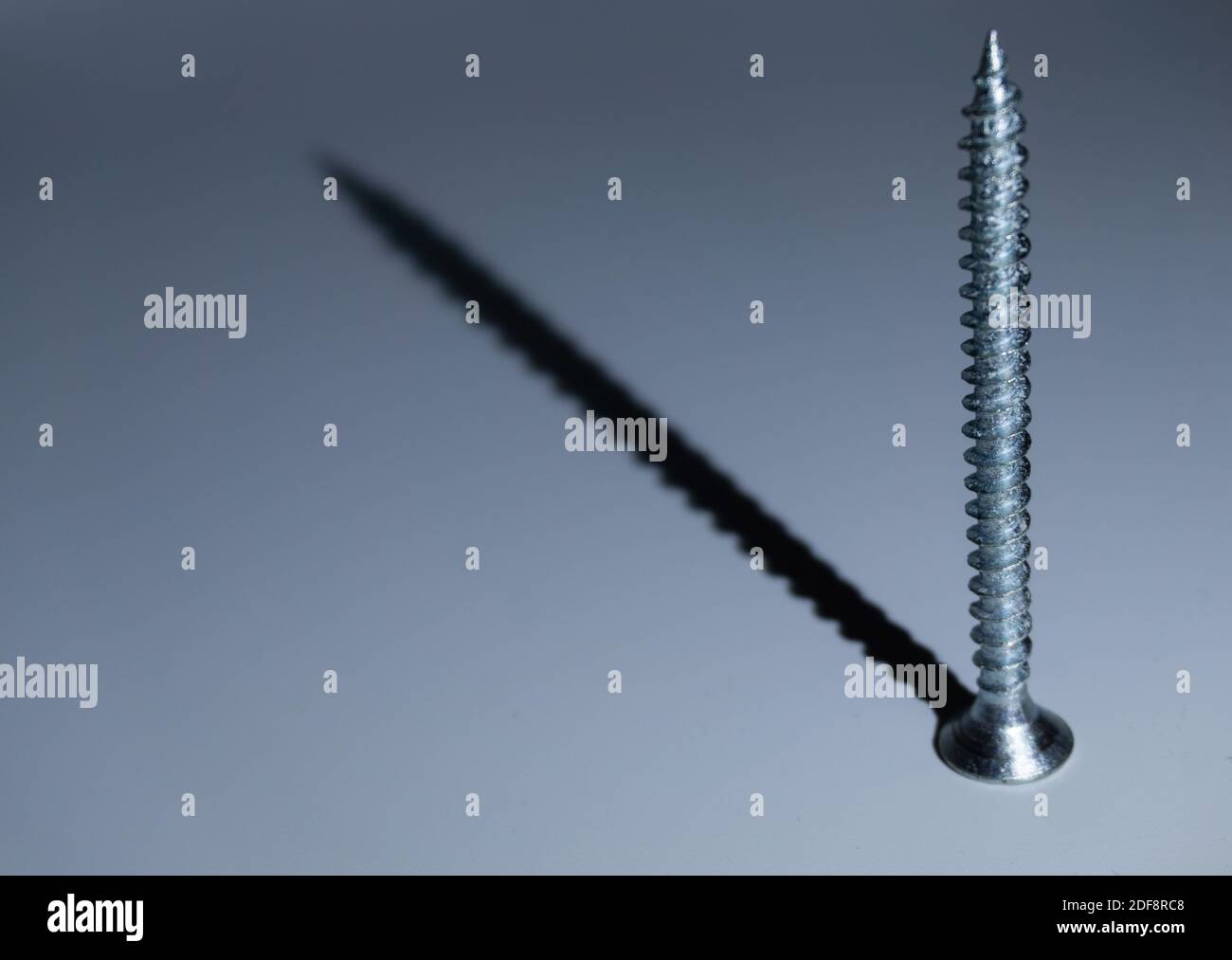 a screw and its shadow on a white background Stock Photo - Alamy