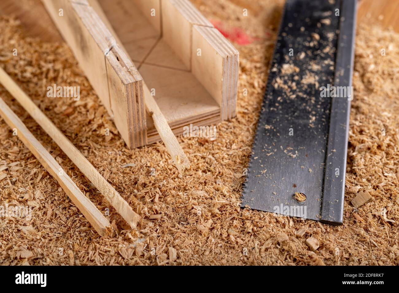 Cutting small pieces of wood with a saw in a carpentry shop. Minor ...