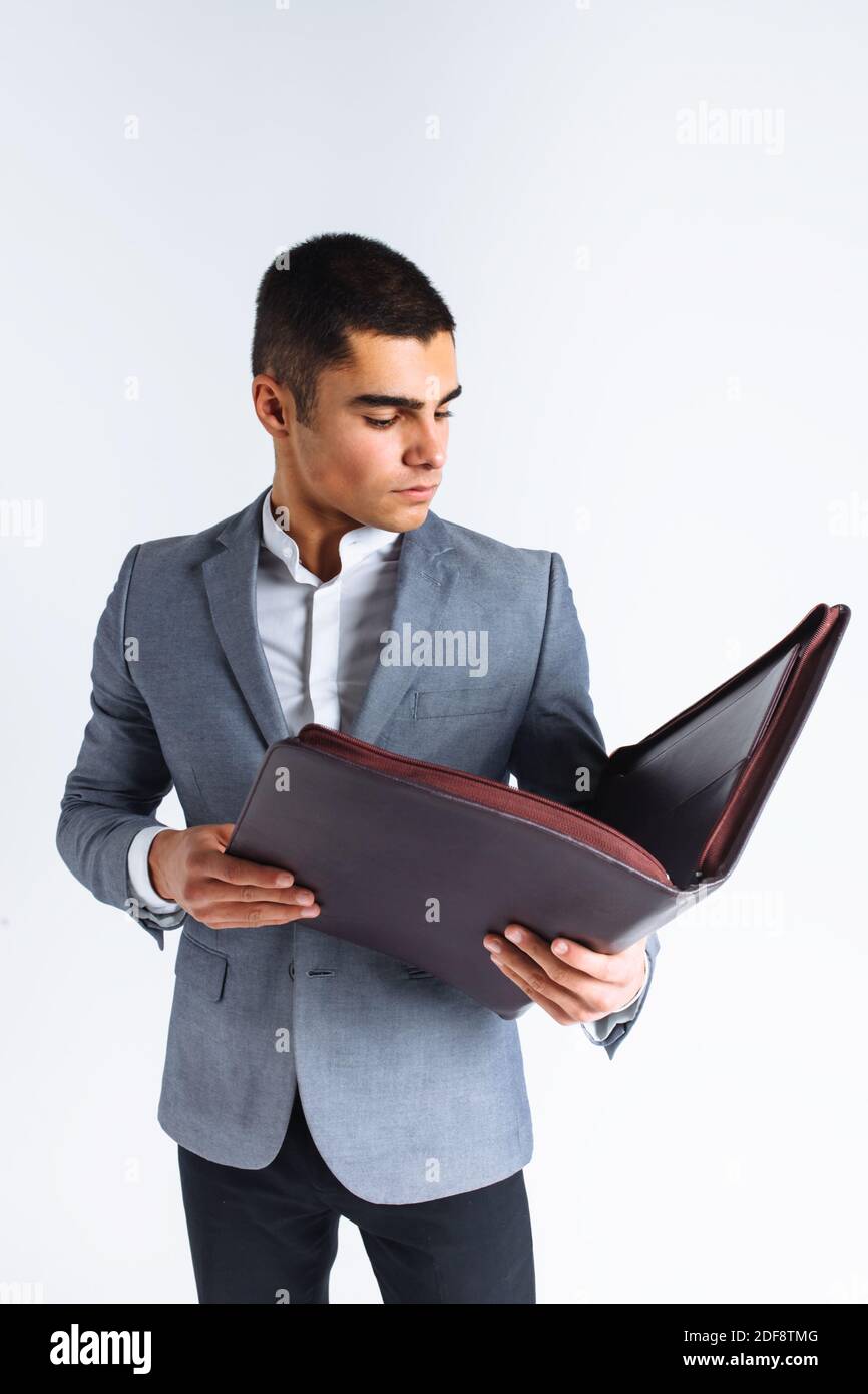 Handsome man with folder man reading a menu, a stylish business guy in ...