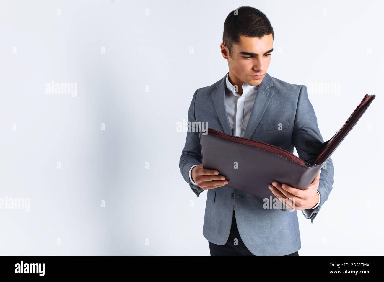 Handsome man with folder man reading a menu, a stylish business guy in ...