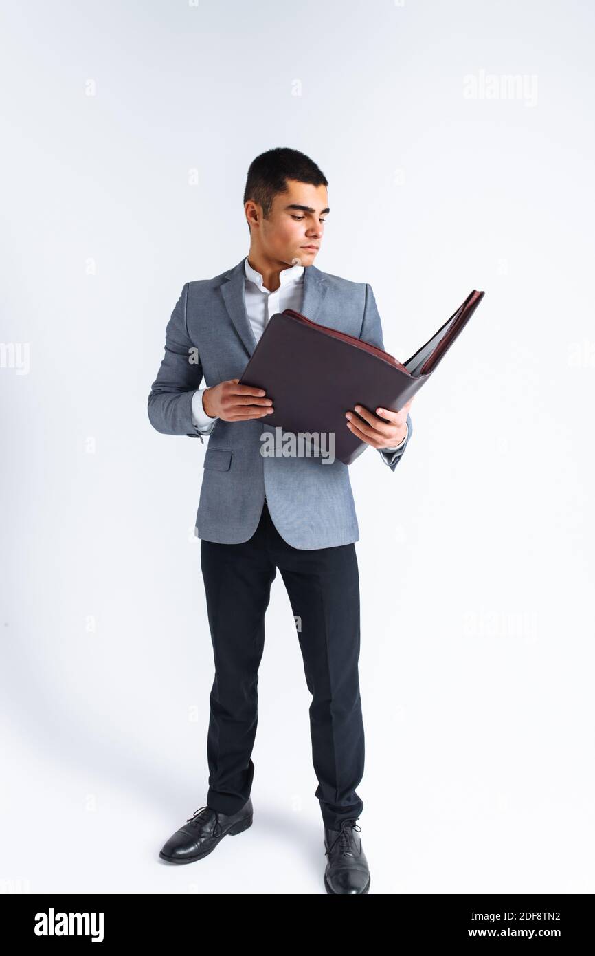 Handsome man with folder man reading a menu, a stylish business guy in ...