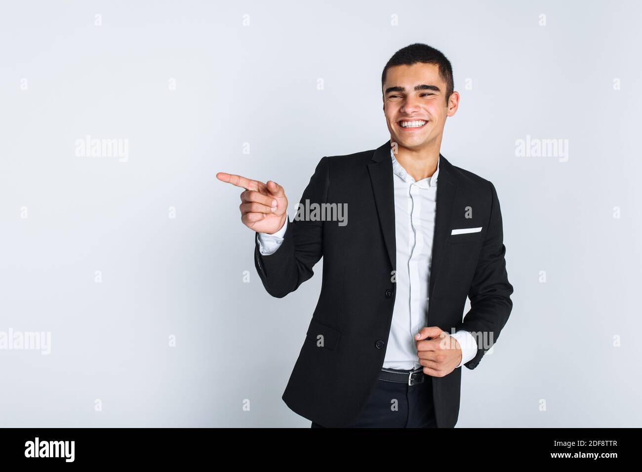 Stylish man pointing finger on isolated background of a beautiful ...